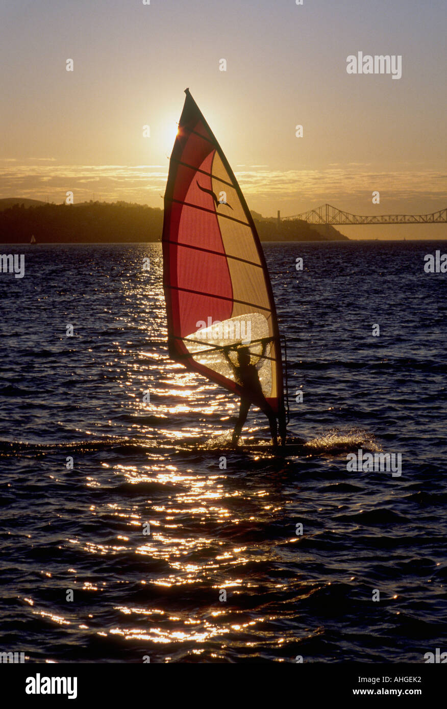 A windsurfer manages wave and wind with the Golden Gate Bridge in ...