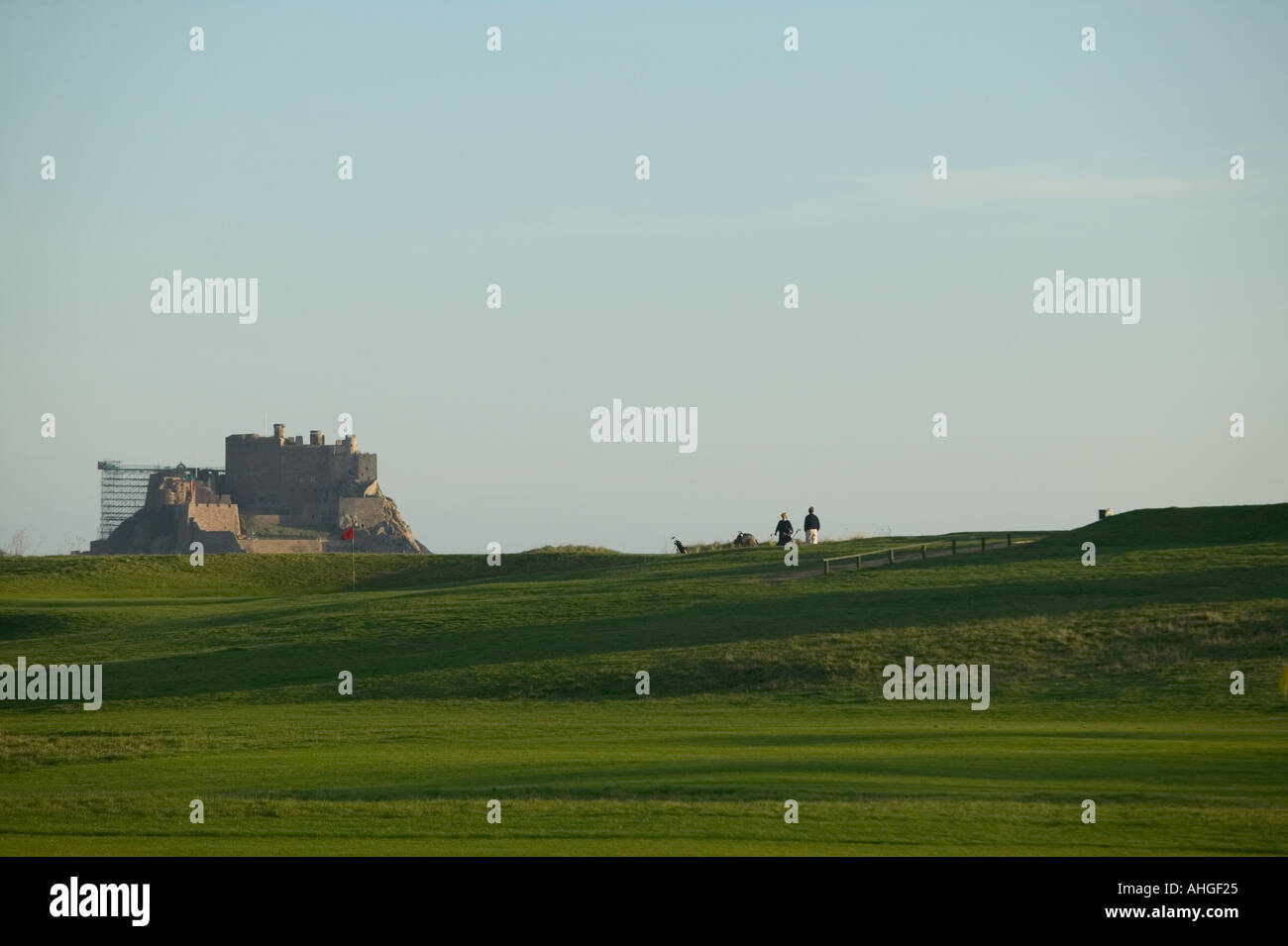 Golf players playing on the Royal Jersey Golf course with Gorey castle ...