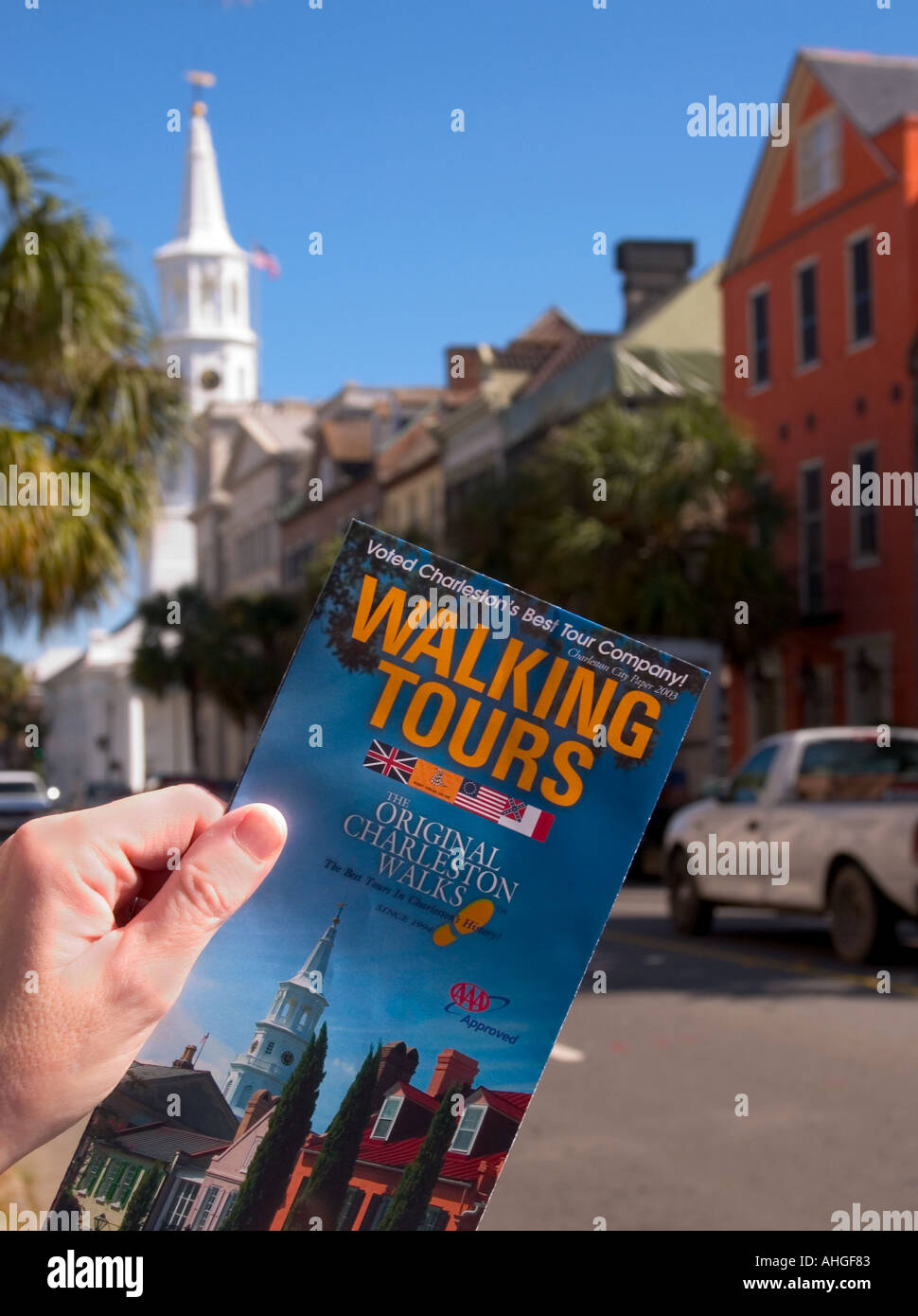Tourist holding a travel brochure while sightseeing in historic ...