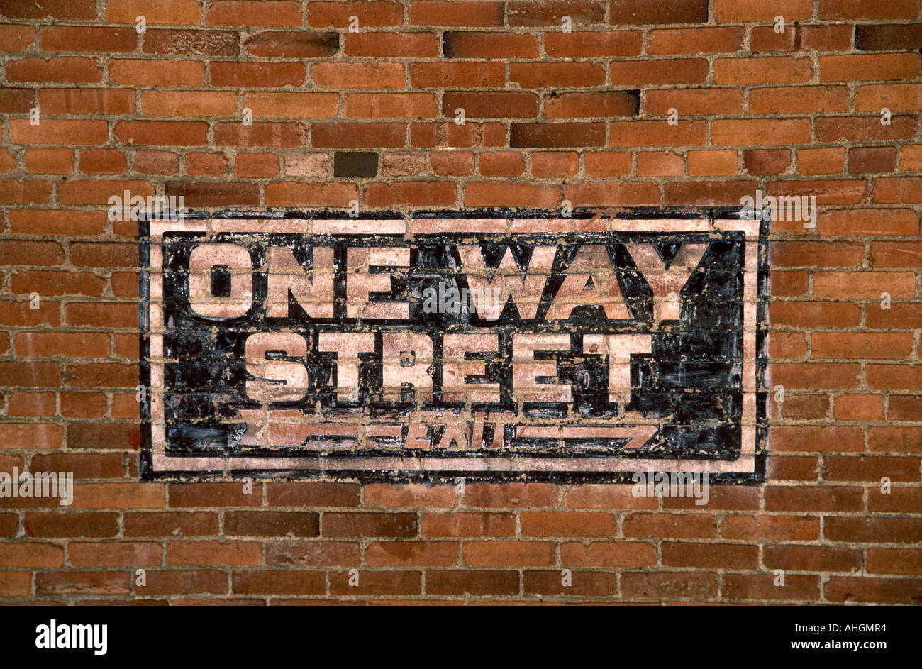 One Way Street sign painted on side of brick building still remains in ...