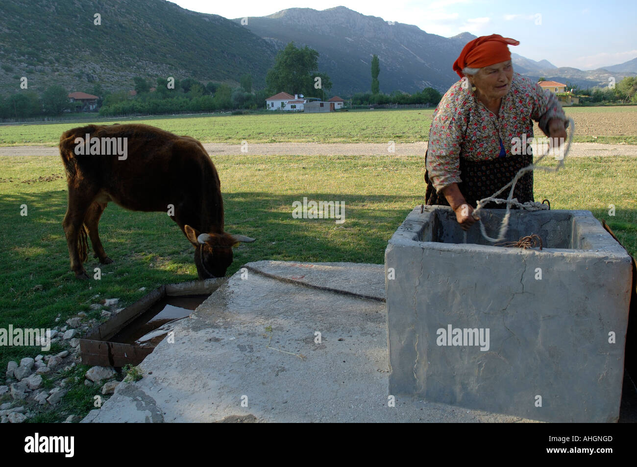 Woman getting water well hi-res stock photography and images - Alamy