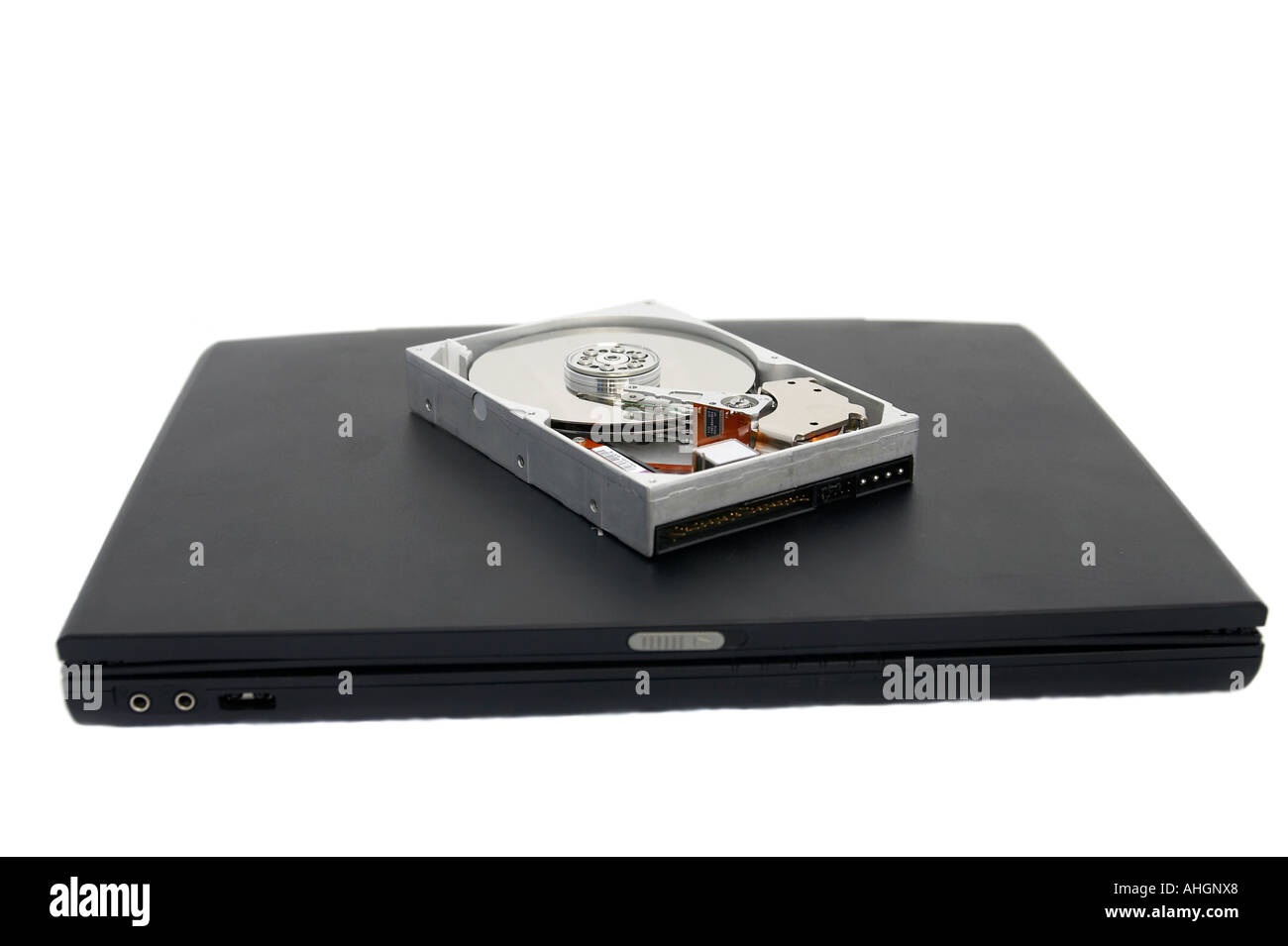 Laptop and open broken hard disc against a white background Stock Photo ...