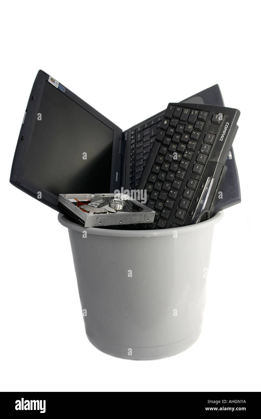 laptop keyboard and open broken hard drive piled into plastic grey bin ...