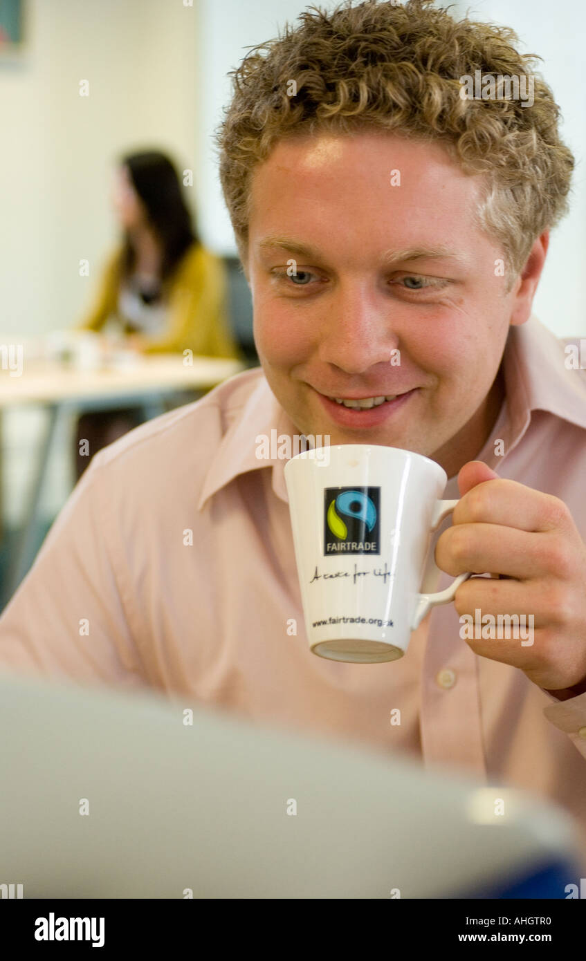 Office worker drinking a cup of Fairtrade coffee Stock Photo - Alamy