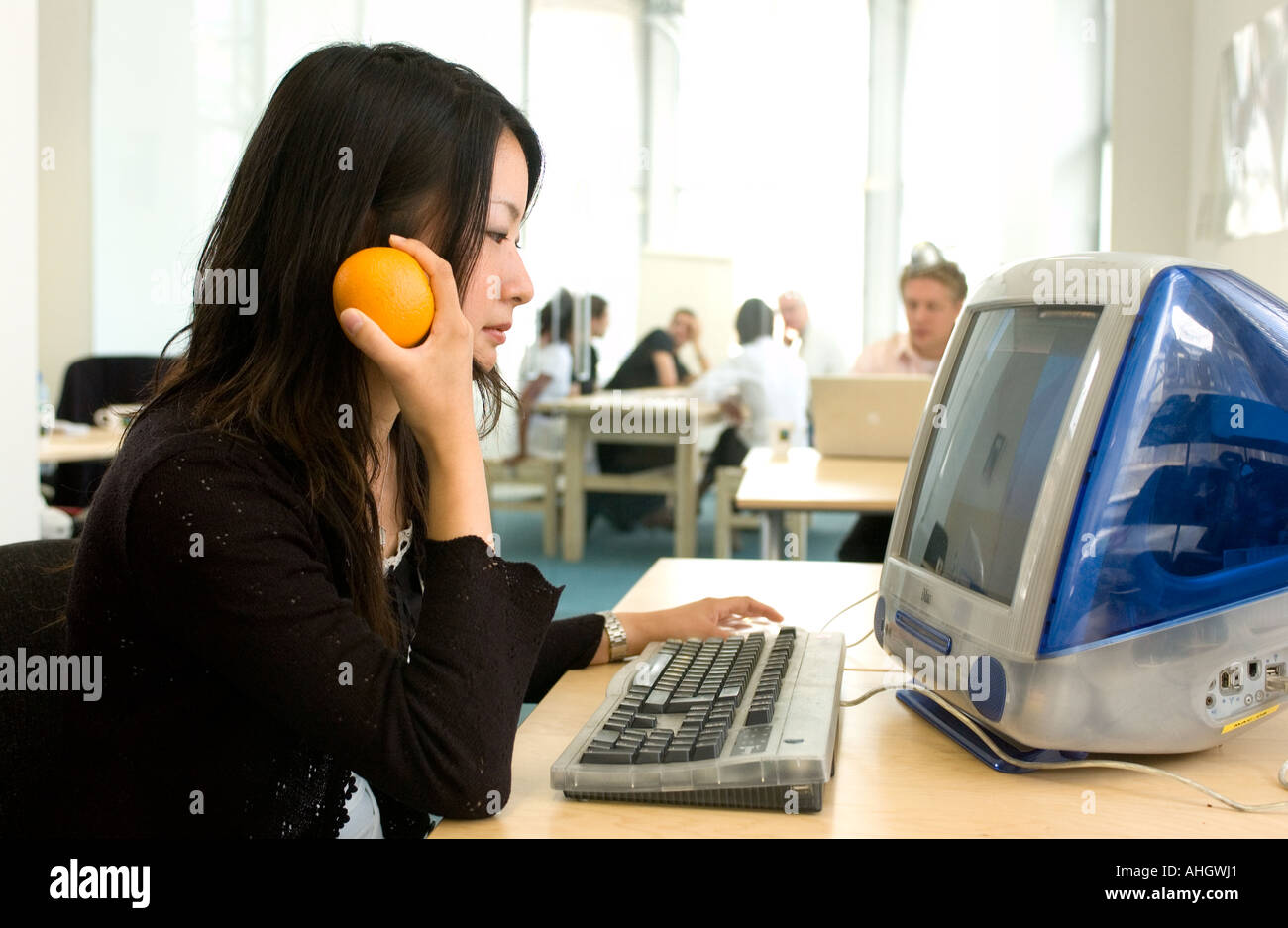 Office worker with Fairtrade orange Stock Photo - Alamy
