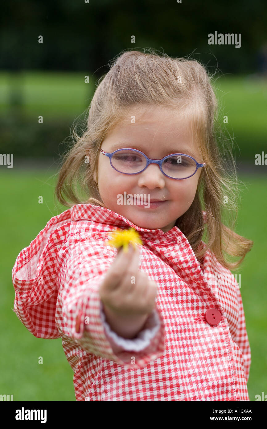 Child offering flower hi-res stock photography and images - Alamy