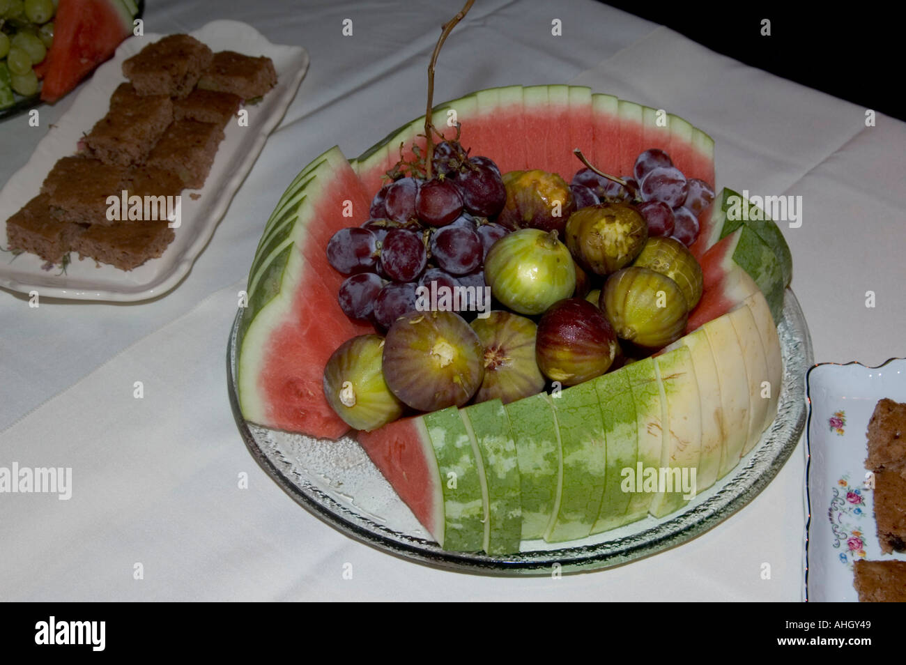 a table set with fruit and cakes buffet Stock Photo - Alamy