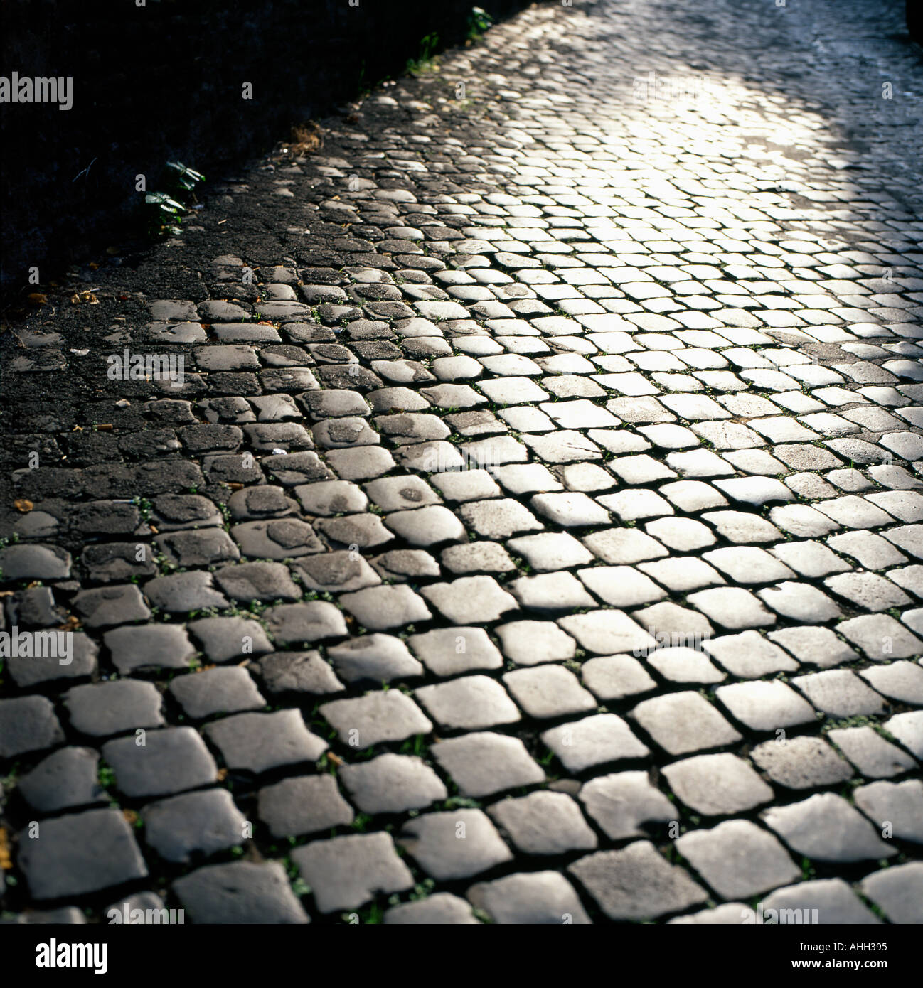 An empty black cobblestone road in Rome Italy KATHY DEWITT Stock Photo ...