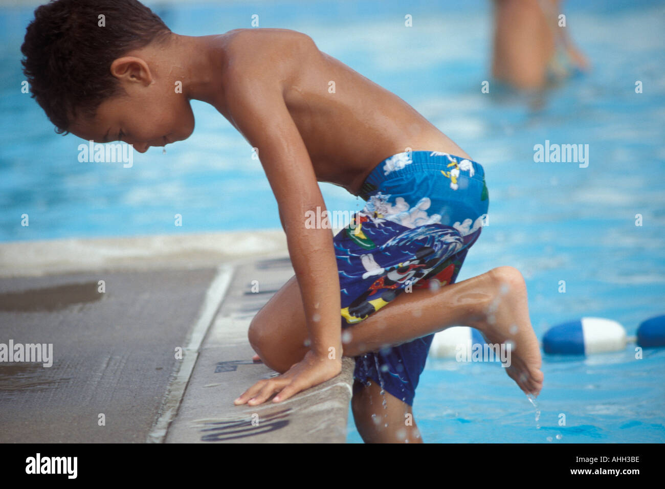 Climbing out of Swimming Pool Stock Photo - Alamy