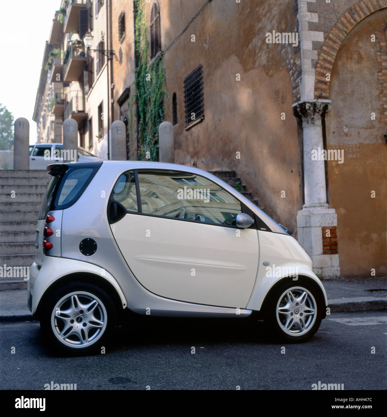 Smart Car Mercedez Benz small fuel efficient parked by some steps in a ...