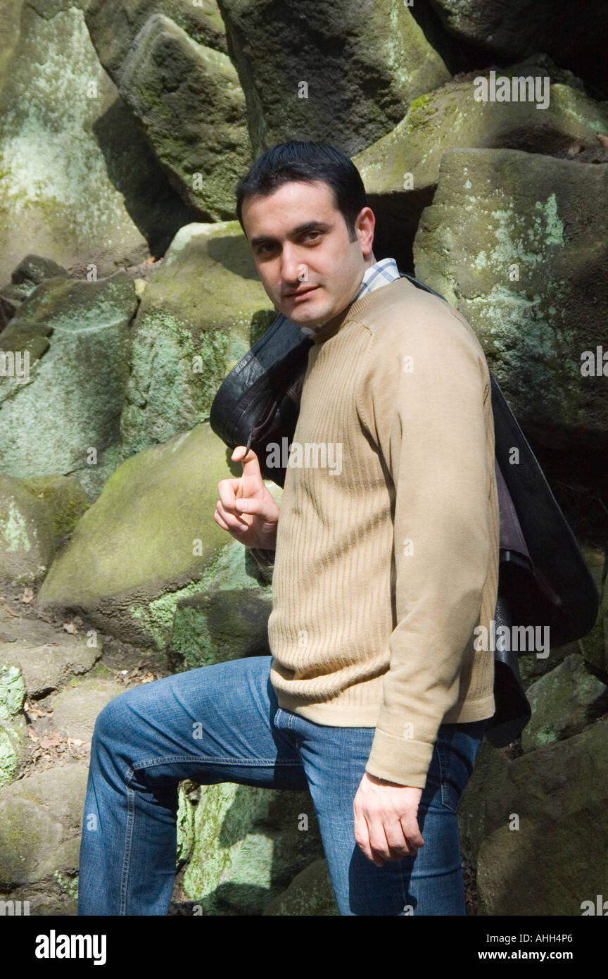 one man standing up holding his jacket Stock Photo - Alamy