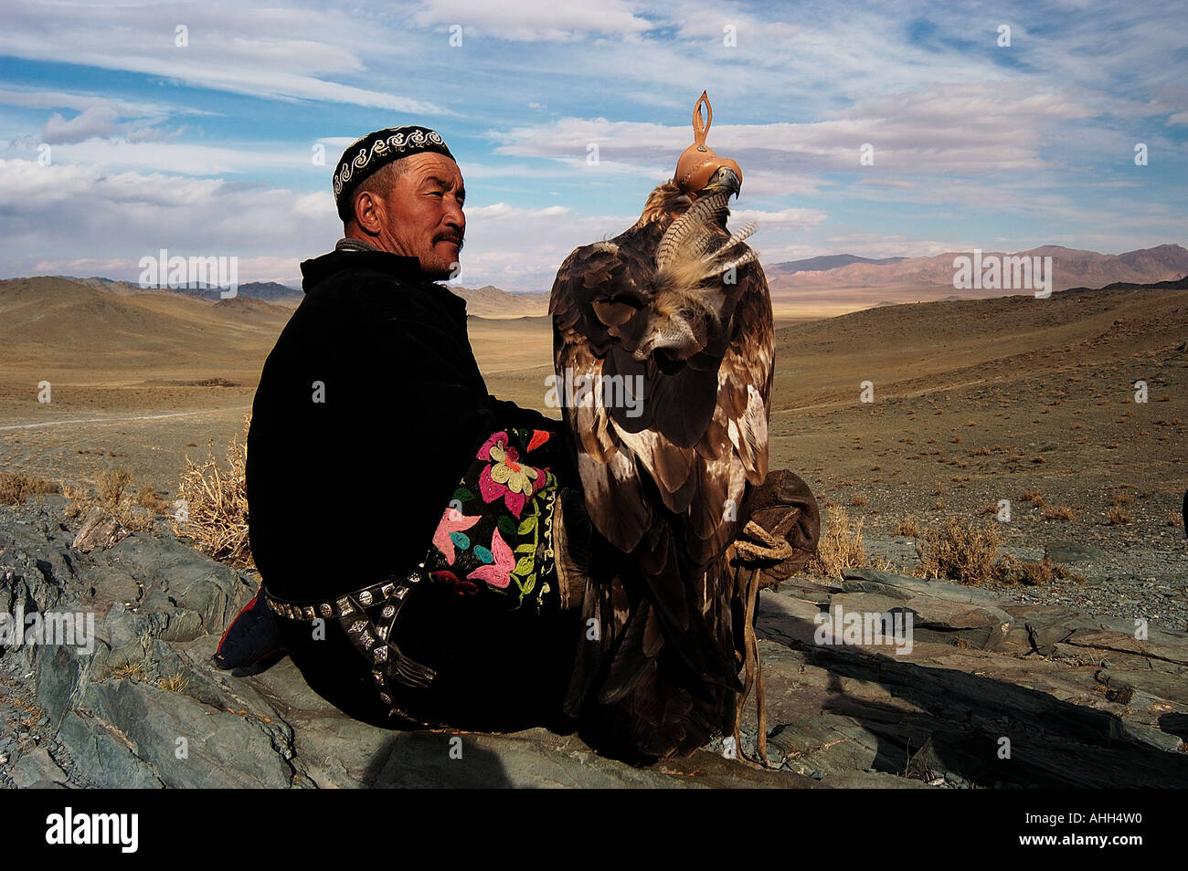 An eagle hunter prepares to demonstrate his eagle for spectators at the ...