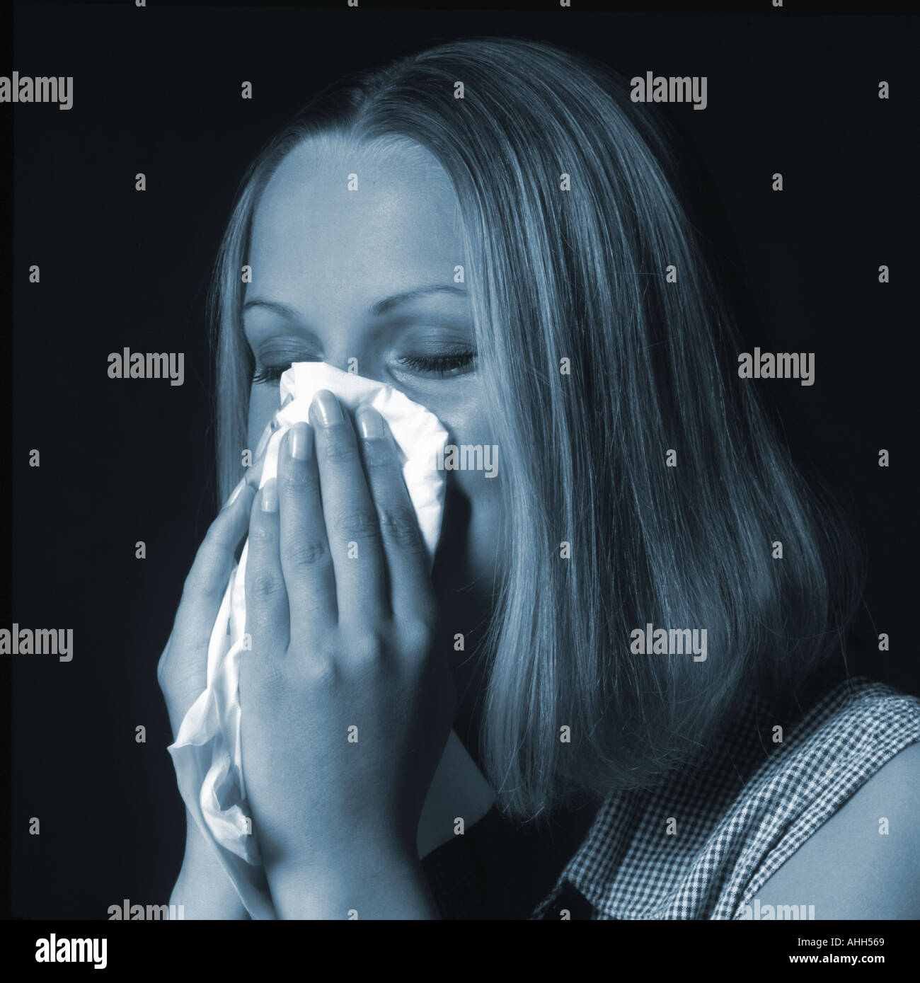 Girl sneezing, using paper handkerchief Stock Photo - Alamy