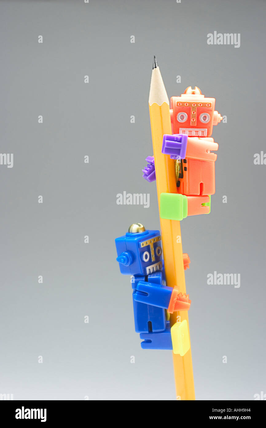 Plastic Robots on Pencil Stock Photo - Alamy