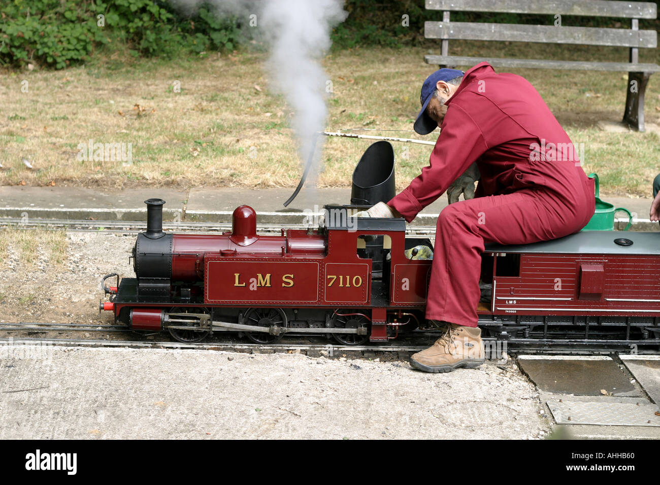 A model railway engineer making an adjustment to his engine before the ...