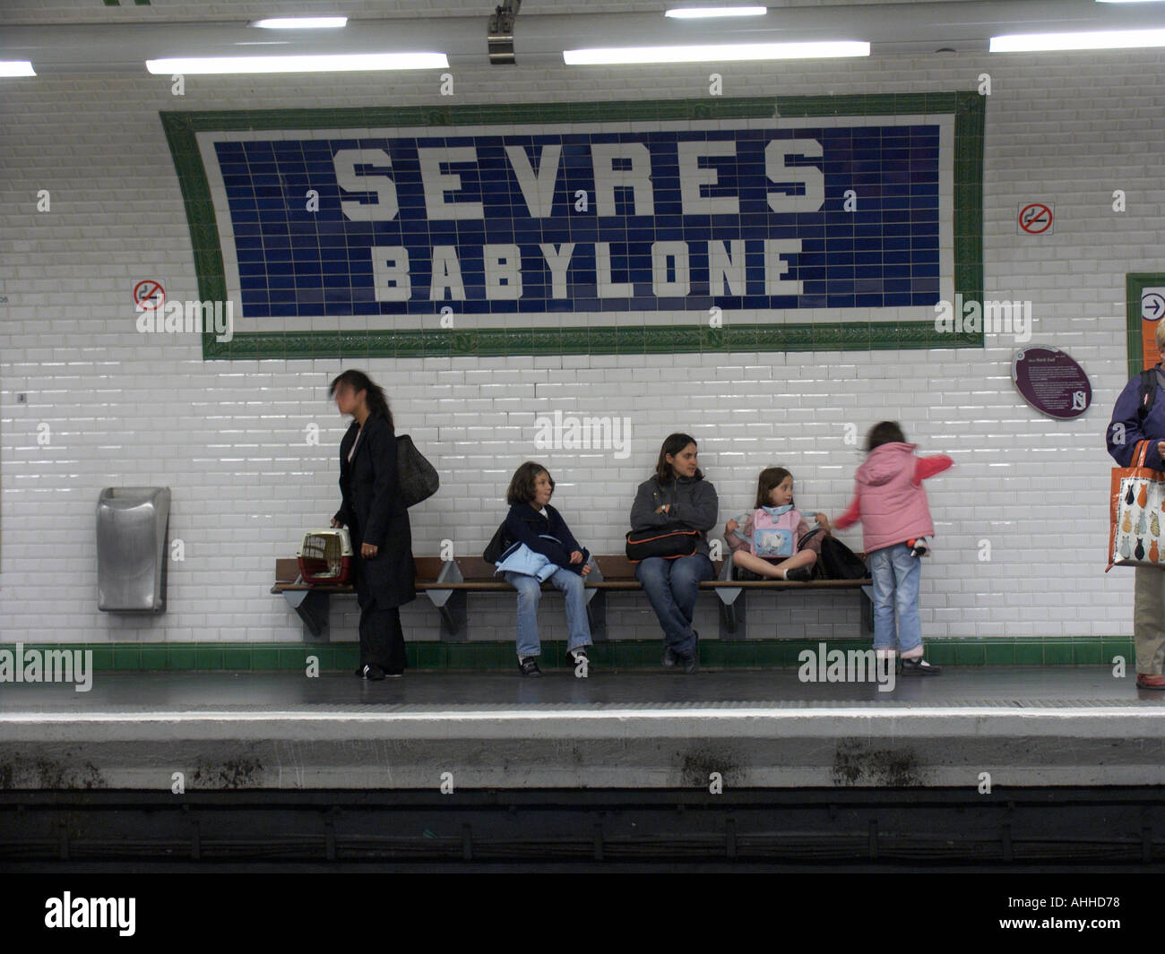 Mother and children sit on bench in Metro station Paris France Stock ...