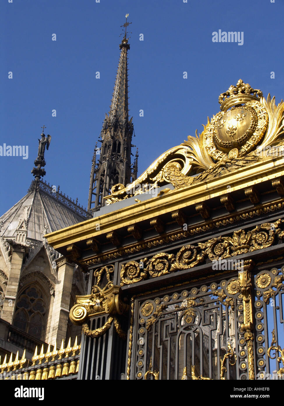 Ornate gate to the Cour du Mai Palais de Justice frame the spire of ...