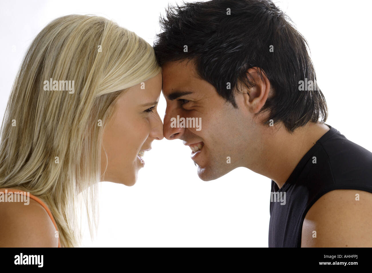 young couple going into a huddle Stock Photo - Alamy