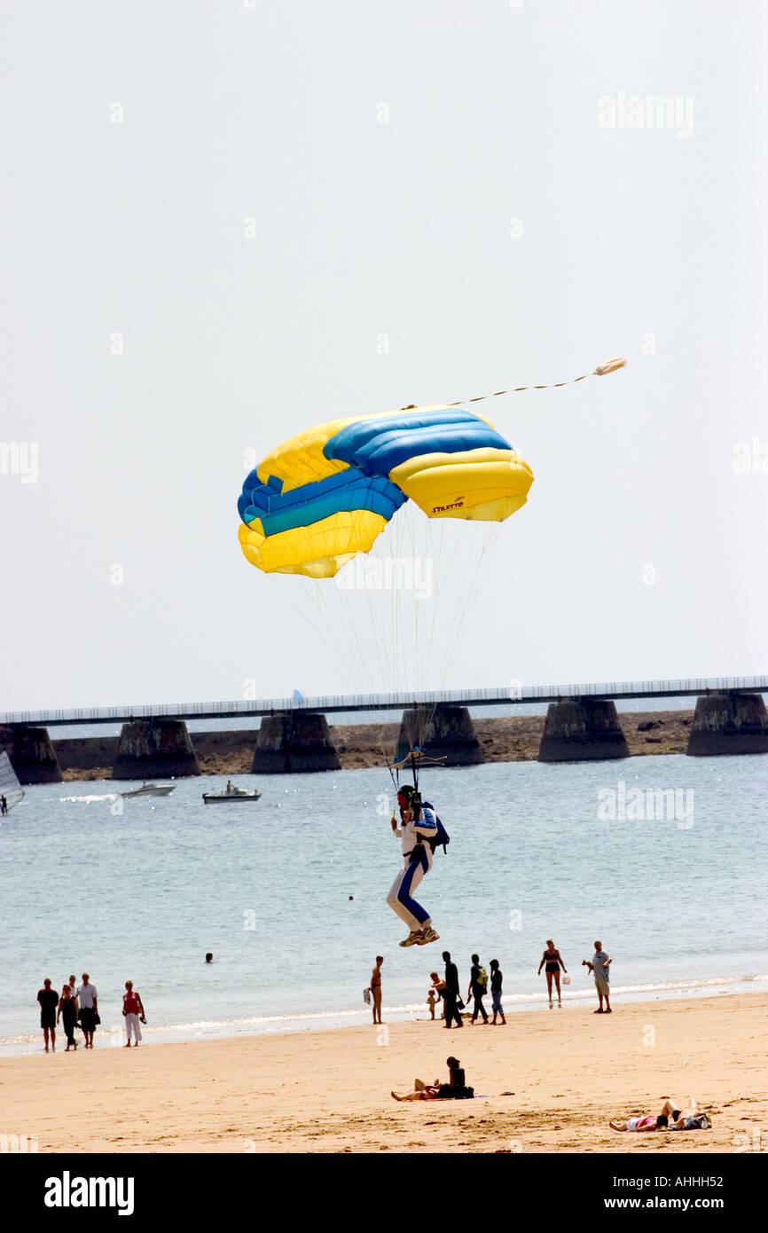 skydiver with colourful parachute landing on beach Stock Photo - Alamy