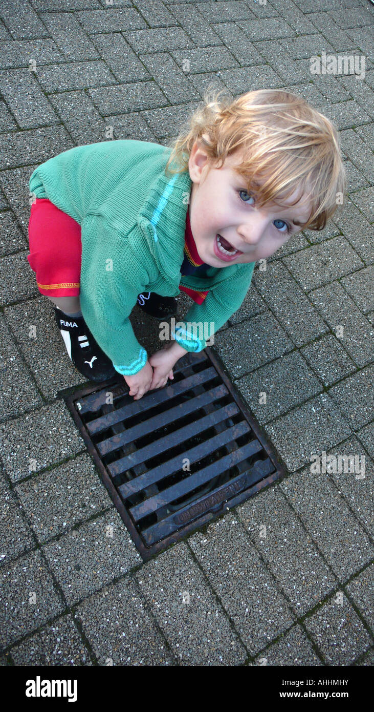 small boy with manhole cover Stock Photo - Alamy