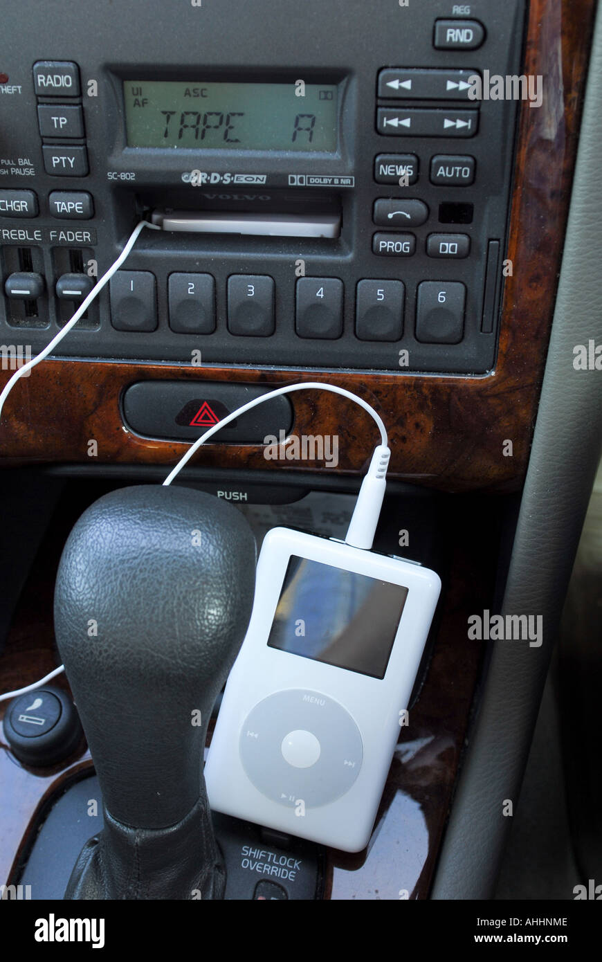An Ipod connected to a cassette player adaptor for listening to music ...