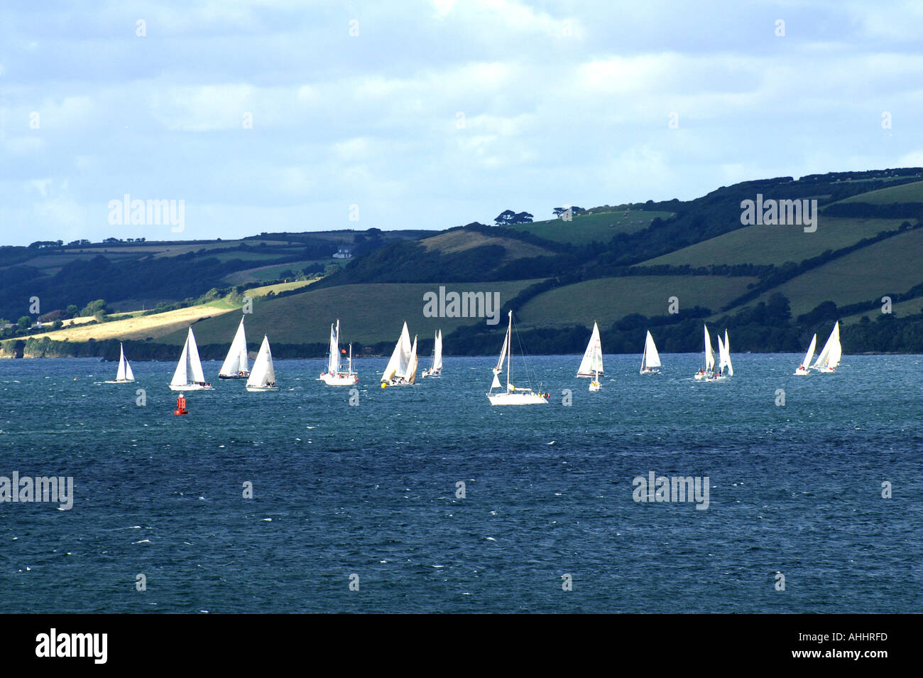 Yachts racing on the Carrick Roads Cornwall dramatic monument coastal ...