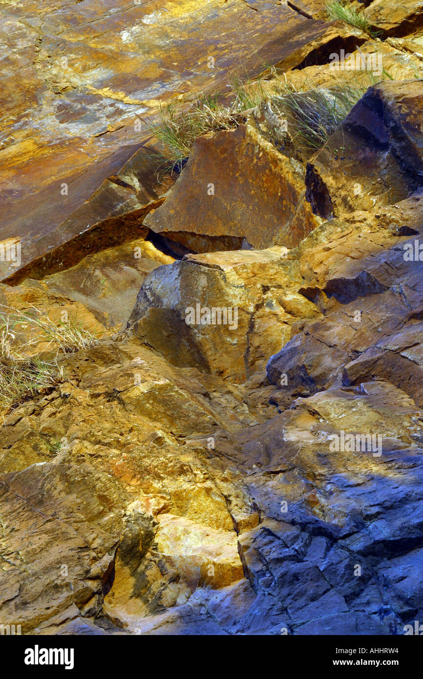 Solid golden rock face during sunset on the banks of the Brisbane River ...