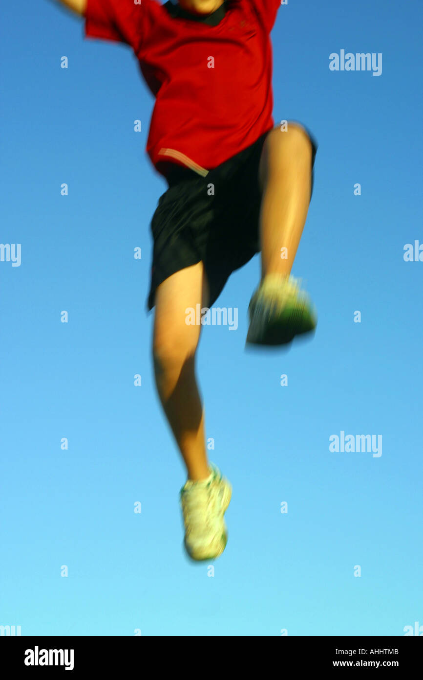 Young boy jumping into the air Stock Photo - Alamy