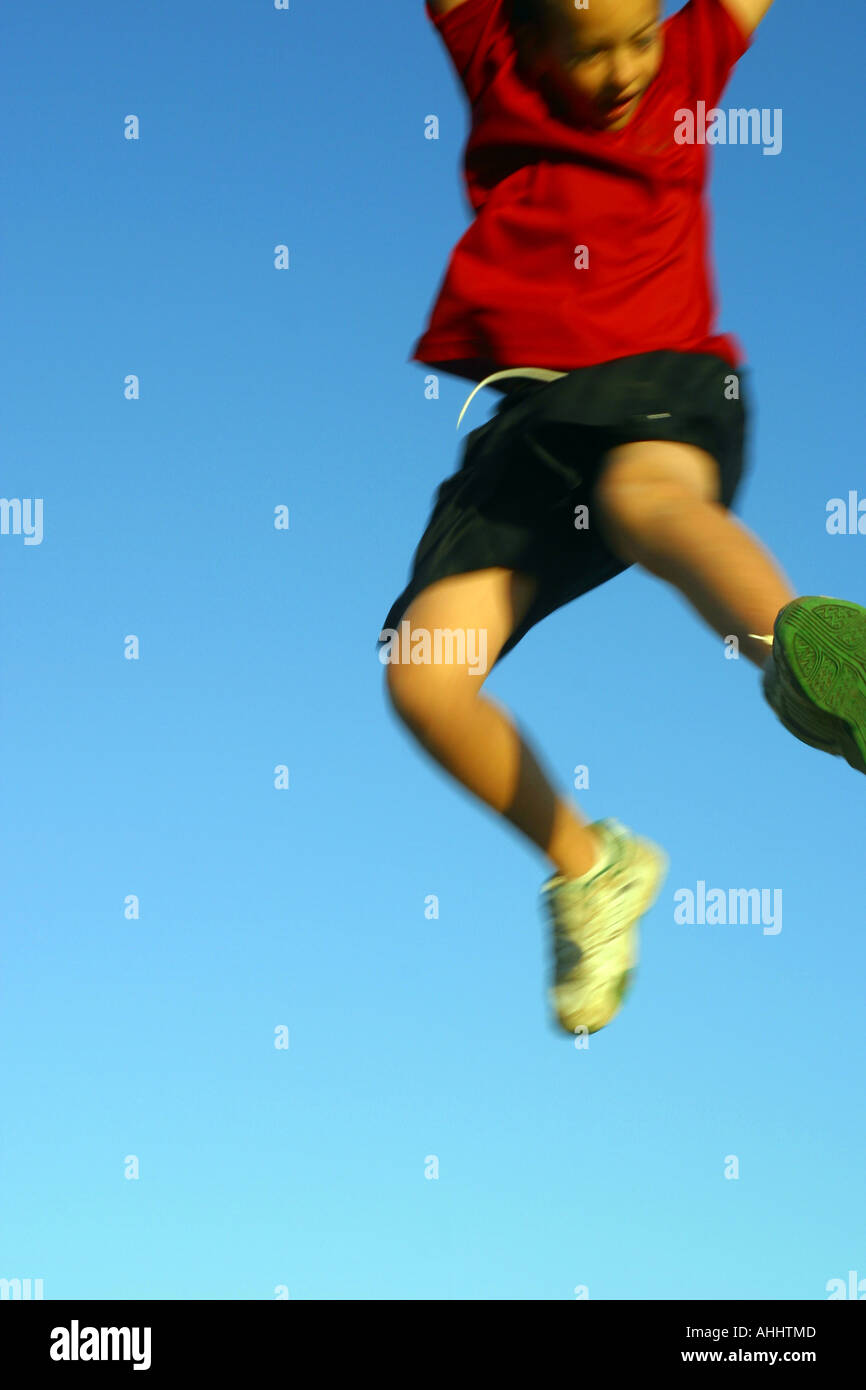 Young boy jumping into the air Stock Photo - Alamy