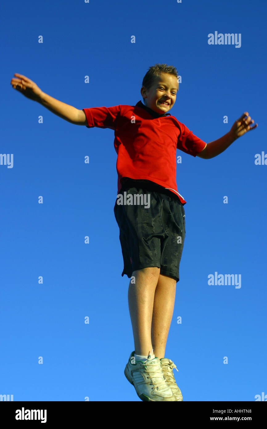 Young boy jumping into the air or falling from the sky Stock Photo - Alamy