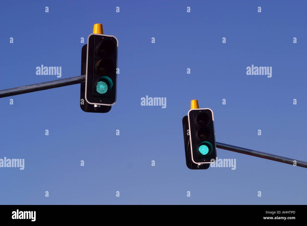 Two sets of traffic lights on green Stock Photo - Alamy