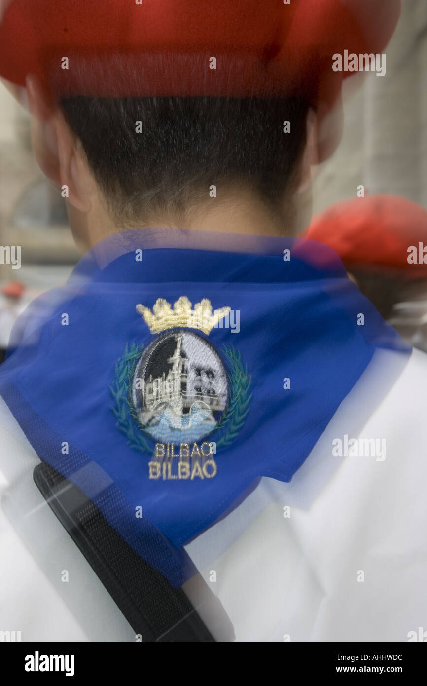 Member of a traditional Basque band wearing red beret and blue neck ...
