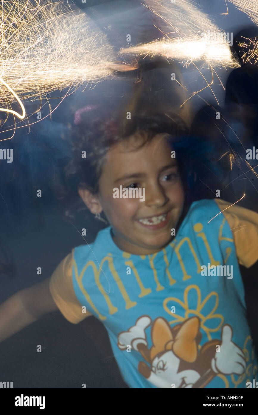 Little girl laughing with delight as she flees from the Bull of Fire ...