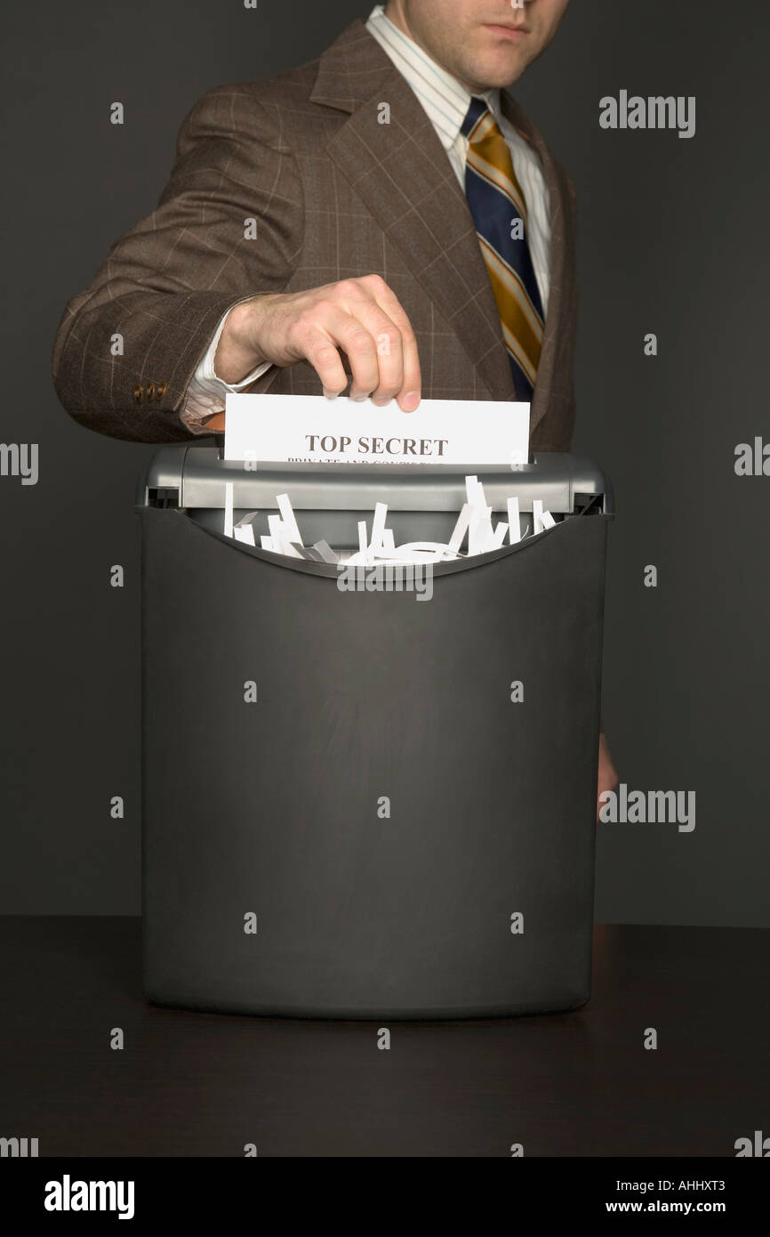 Businessman shredding document Stock Photo - Alamy