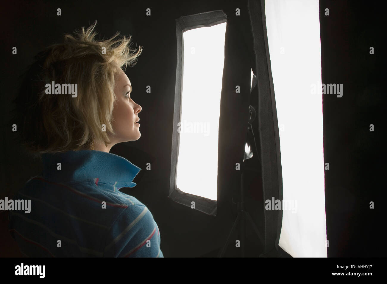 Woman looking into a light Stock Photo - Alamy