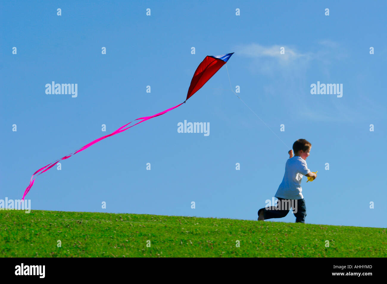 Young boy flying a kite Stock Photo - Alamy