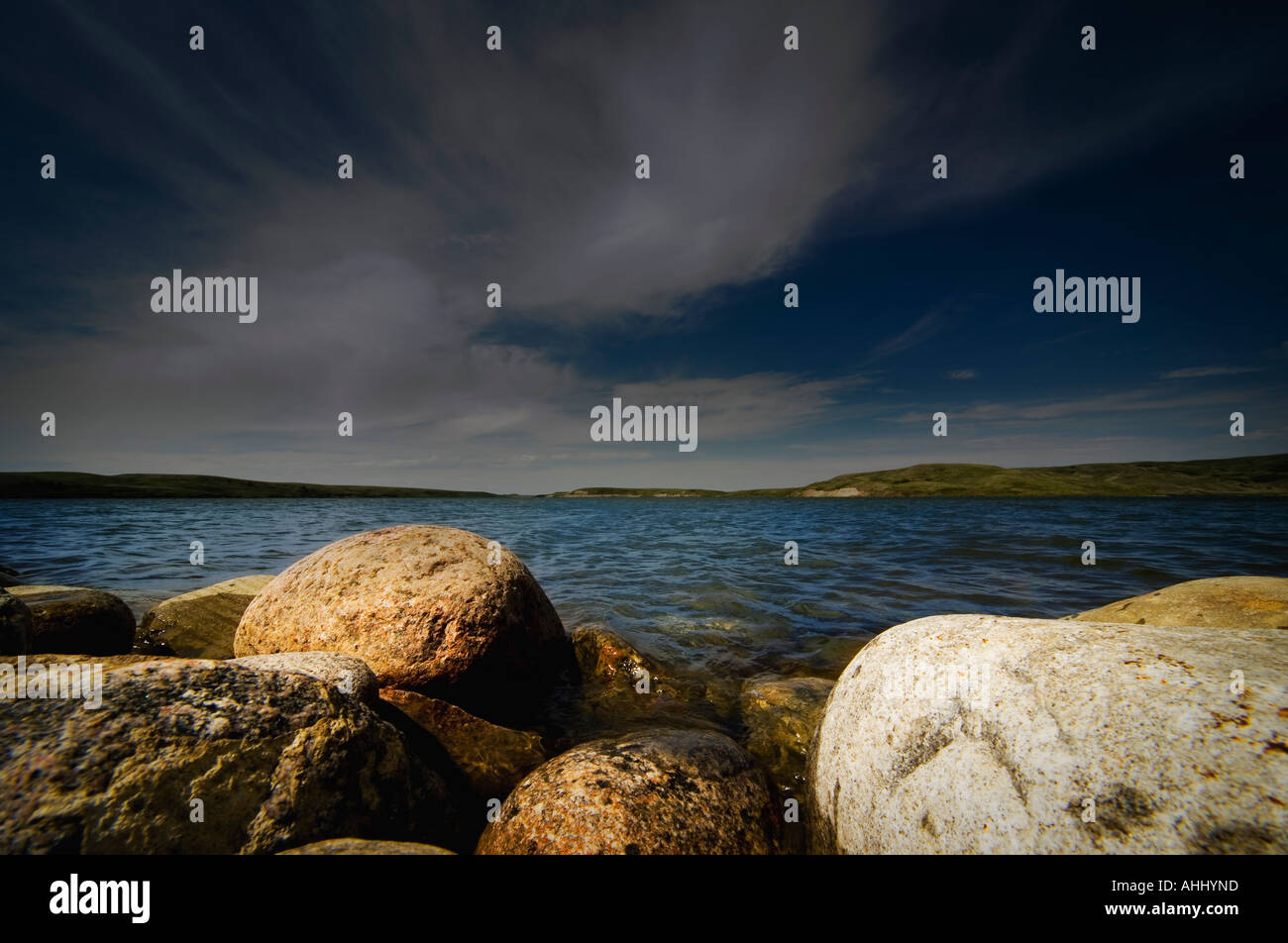 Rocks at edge of lake Stock Photo - Alamy