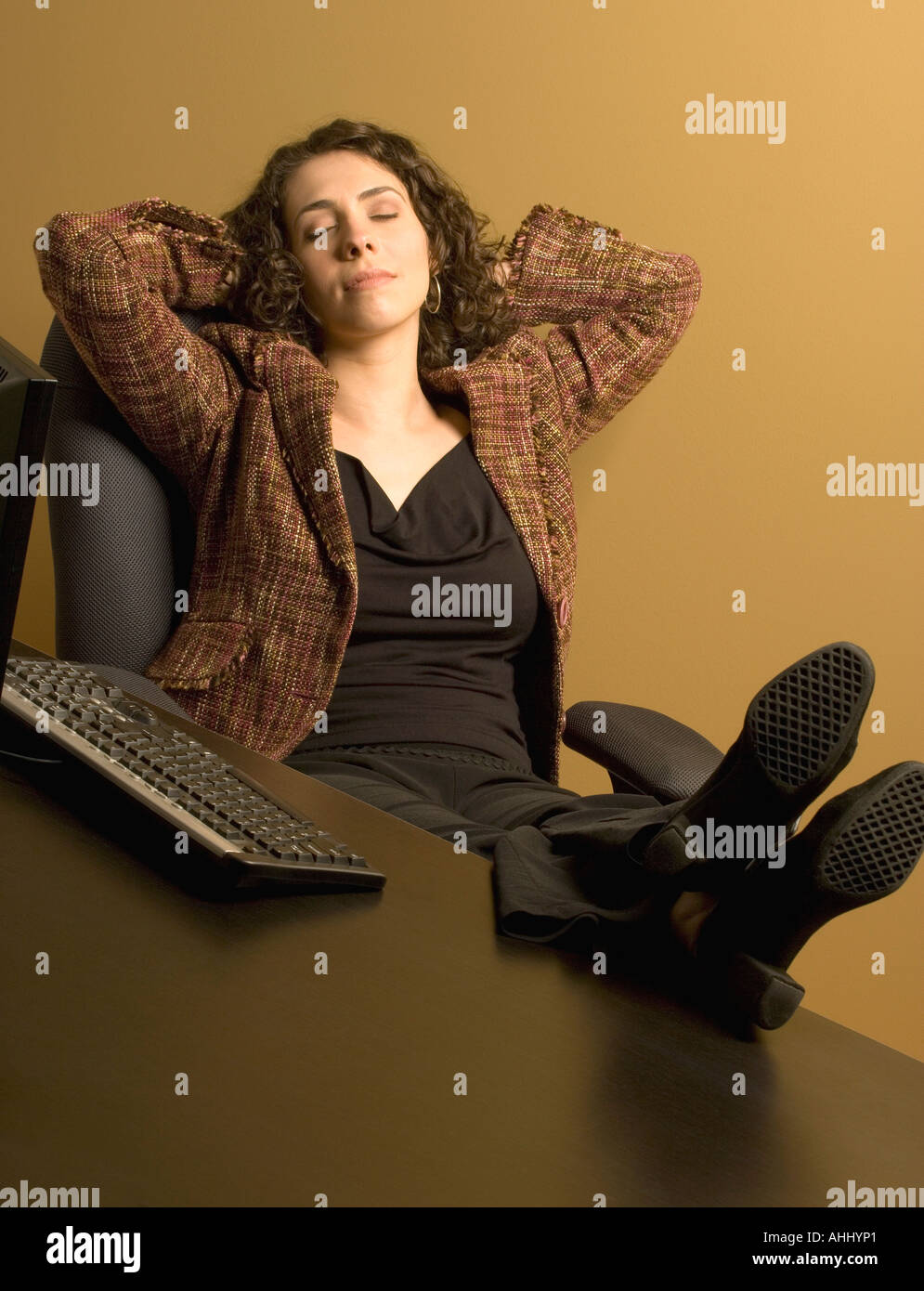 Woman resting at her desk Stock Photo - Alamy