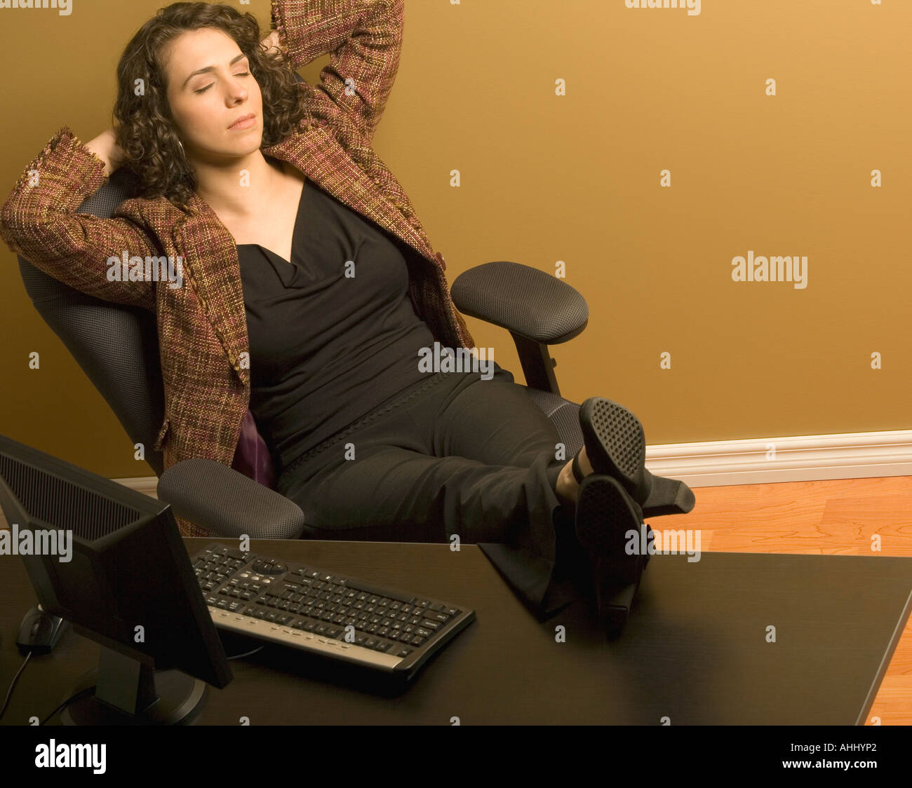 Woman resting at her desk Stock Photo - Alamy