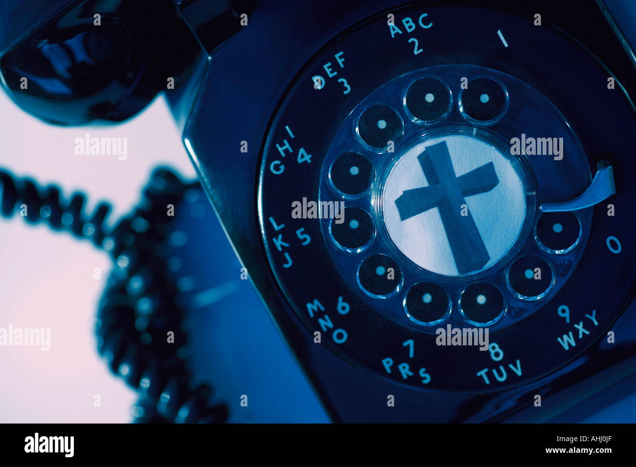 A rotary phone with a cross Stock Photo - Alamy
