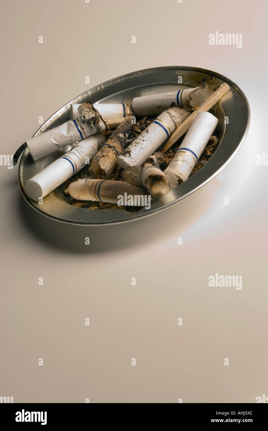 Full ashtray receptacle Stock Photo - Alamy