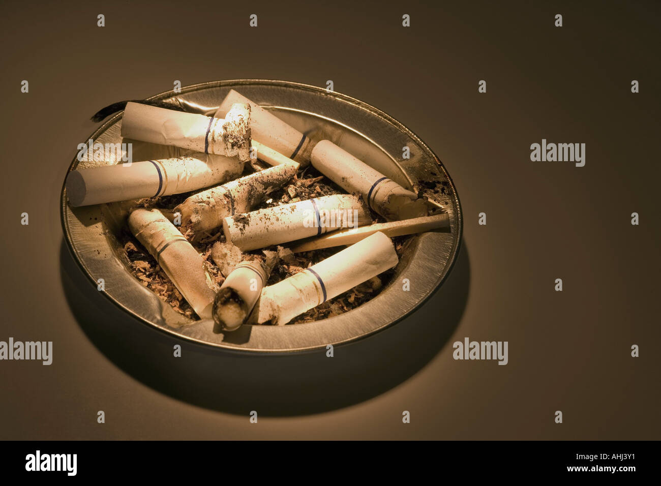 Full ashtray receptacle Stock Photo - Alamy