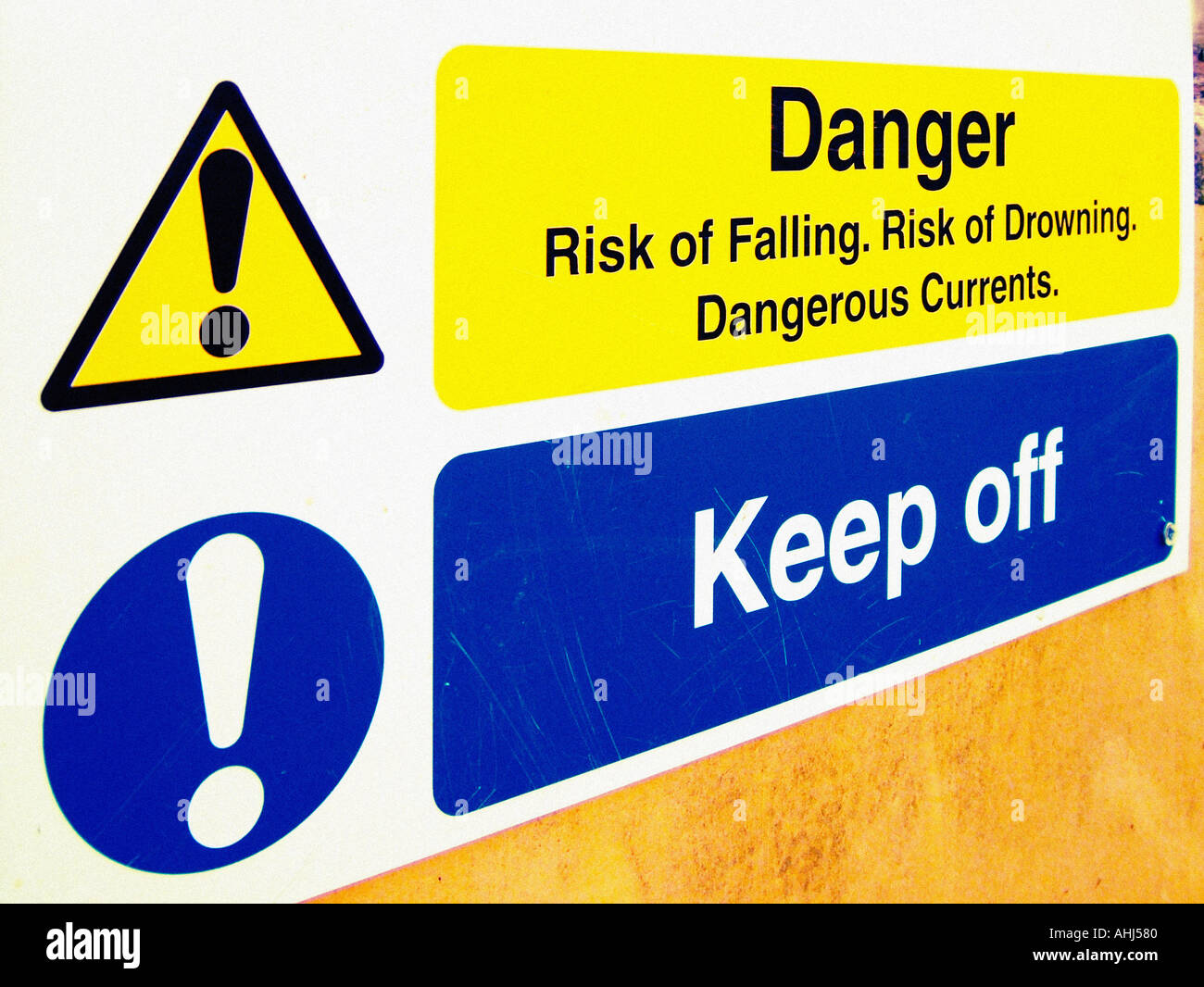 Blue and Yellow Danger Keep off sign at river edge Stock Photo - Alamy