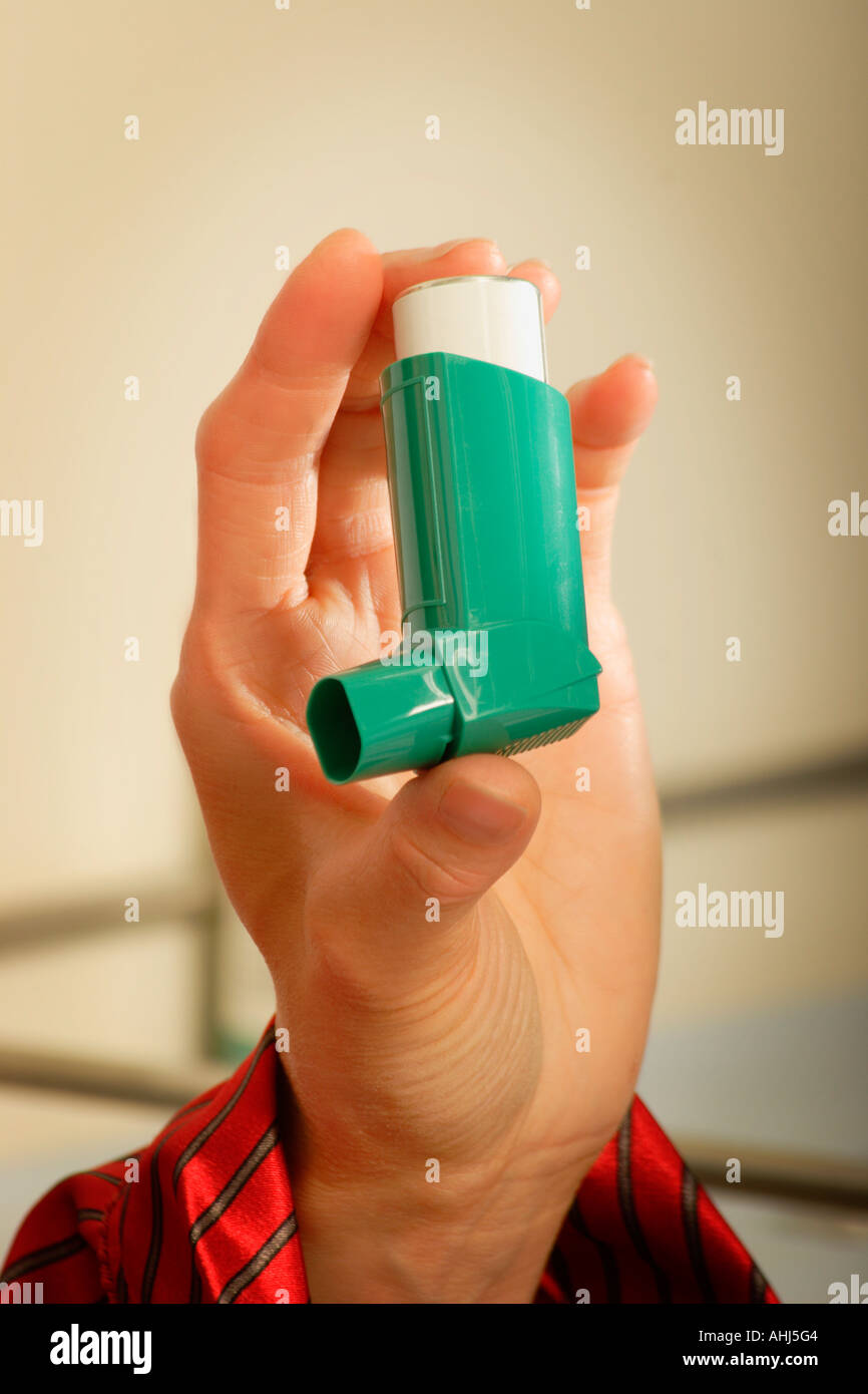 Hand holding an inhaler Stock Photo - Alamy