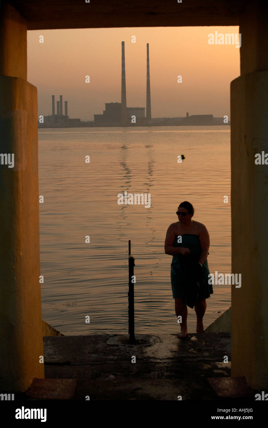 Bather leaves the water after evening swim Stock Photo - Alamy