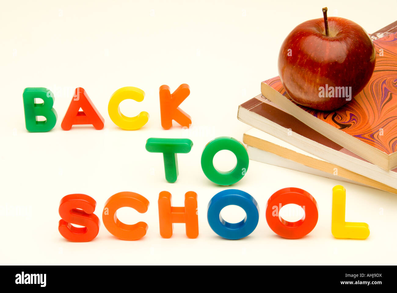 School Books with red apple and the phrase back to school using ...