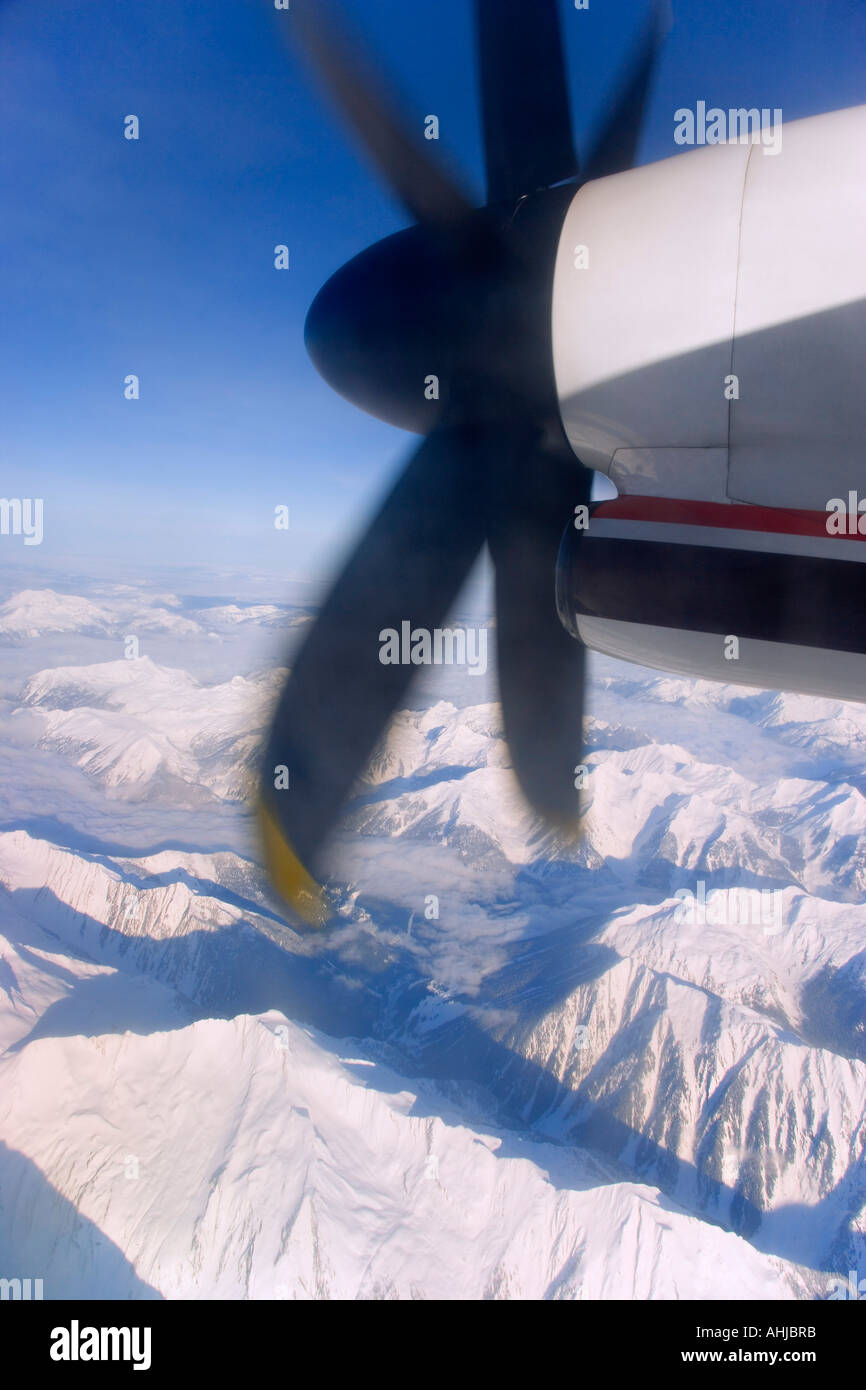 Airplane in flight over mountains Stock Photo - Alamy