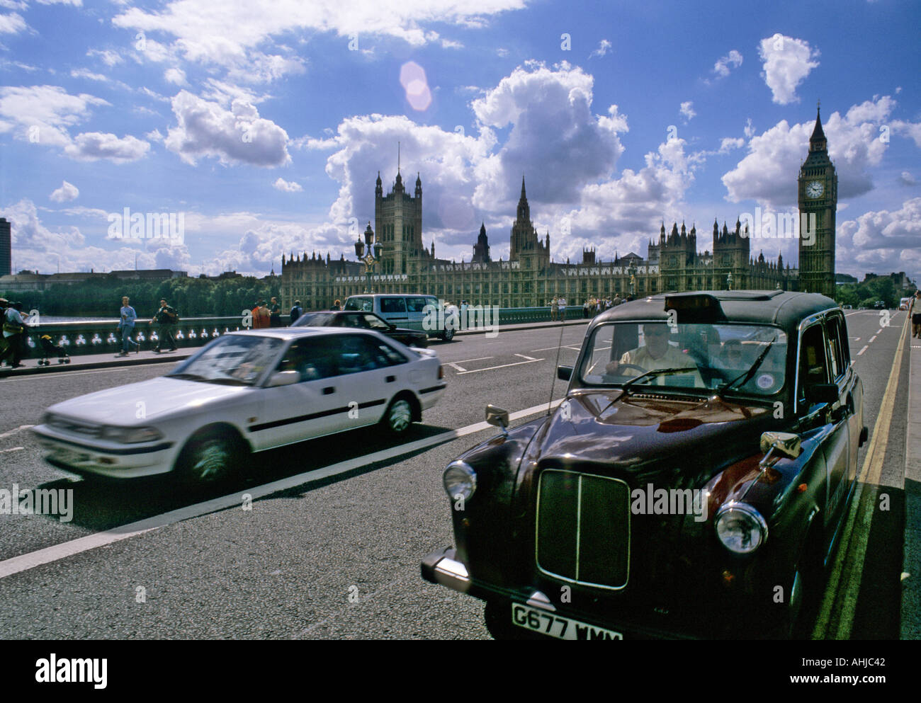 Traditional London black cab on Westminster Bridge with Houses of ...