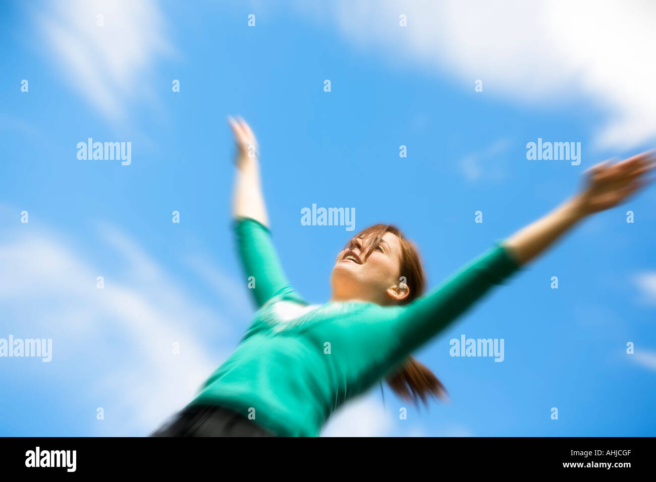Girl with arms raised Stock Photo - Alamy