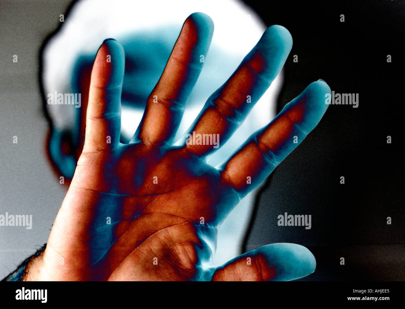 abstract view of man shielding face with hand Stock Photo - Alamy